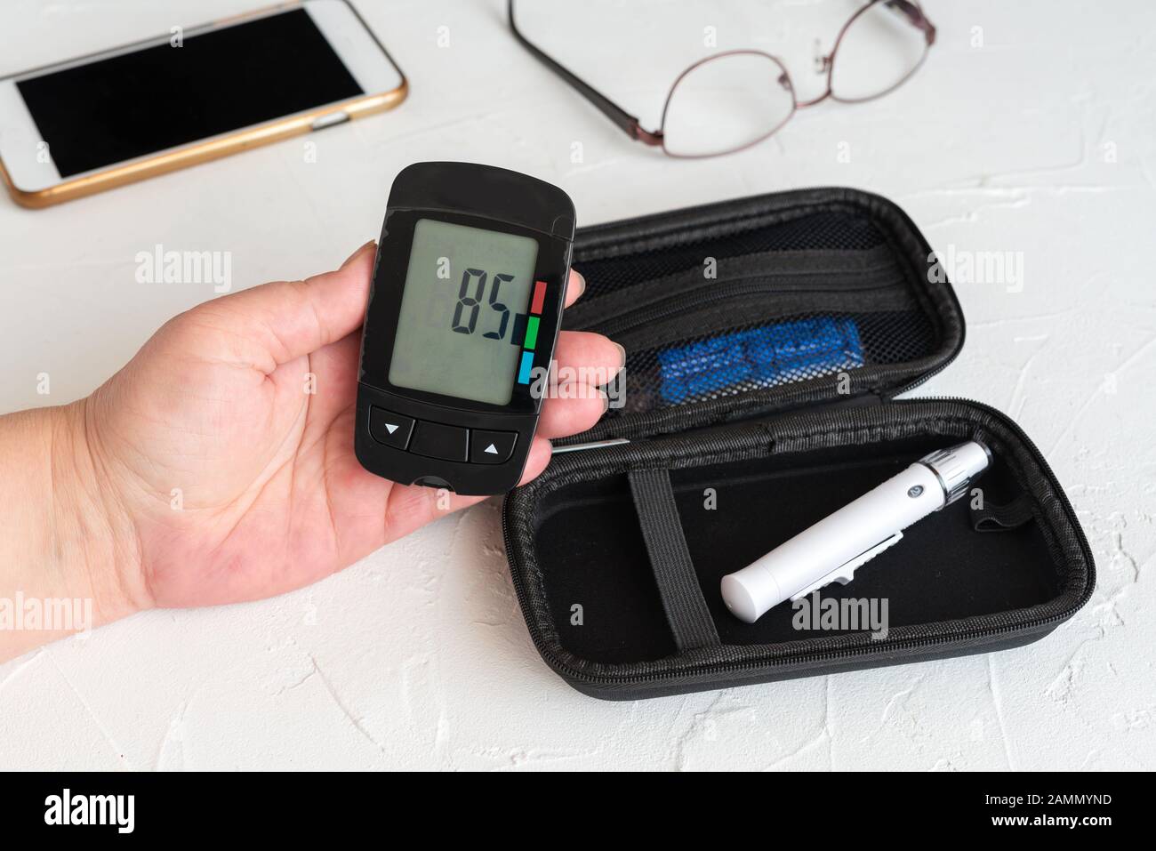 Patient hands measuring glucose level blood test with glucometer Stock ...