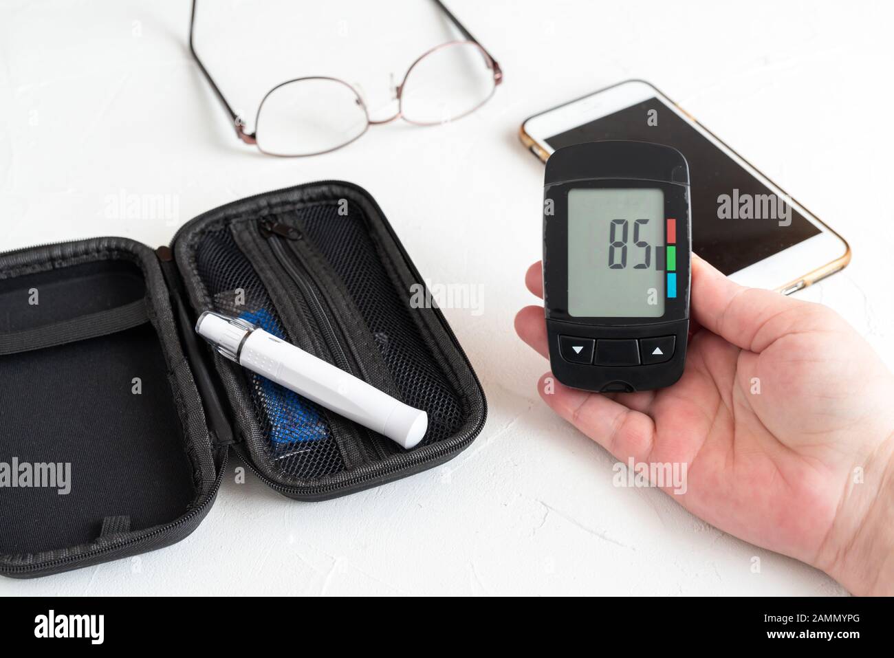 Patient hands measuring glucose level blood test with glucometer Stock ...
