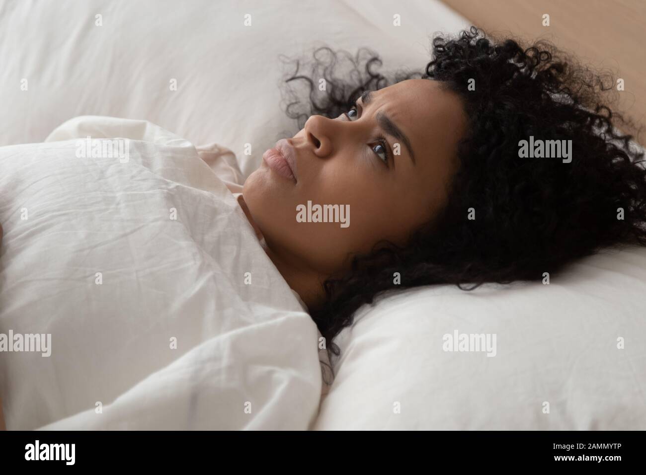 Woman lying in bed cannot fall asleep suffers from insomnia Stock Photo ...