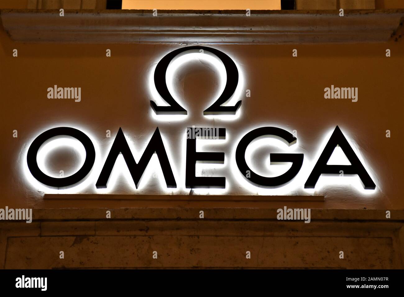 OMEGA LOGO ON THE WALL IN THE NIGHT Stock Photo - Alamy