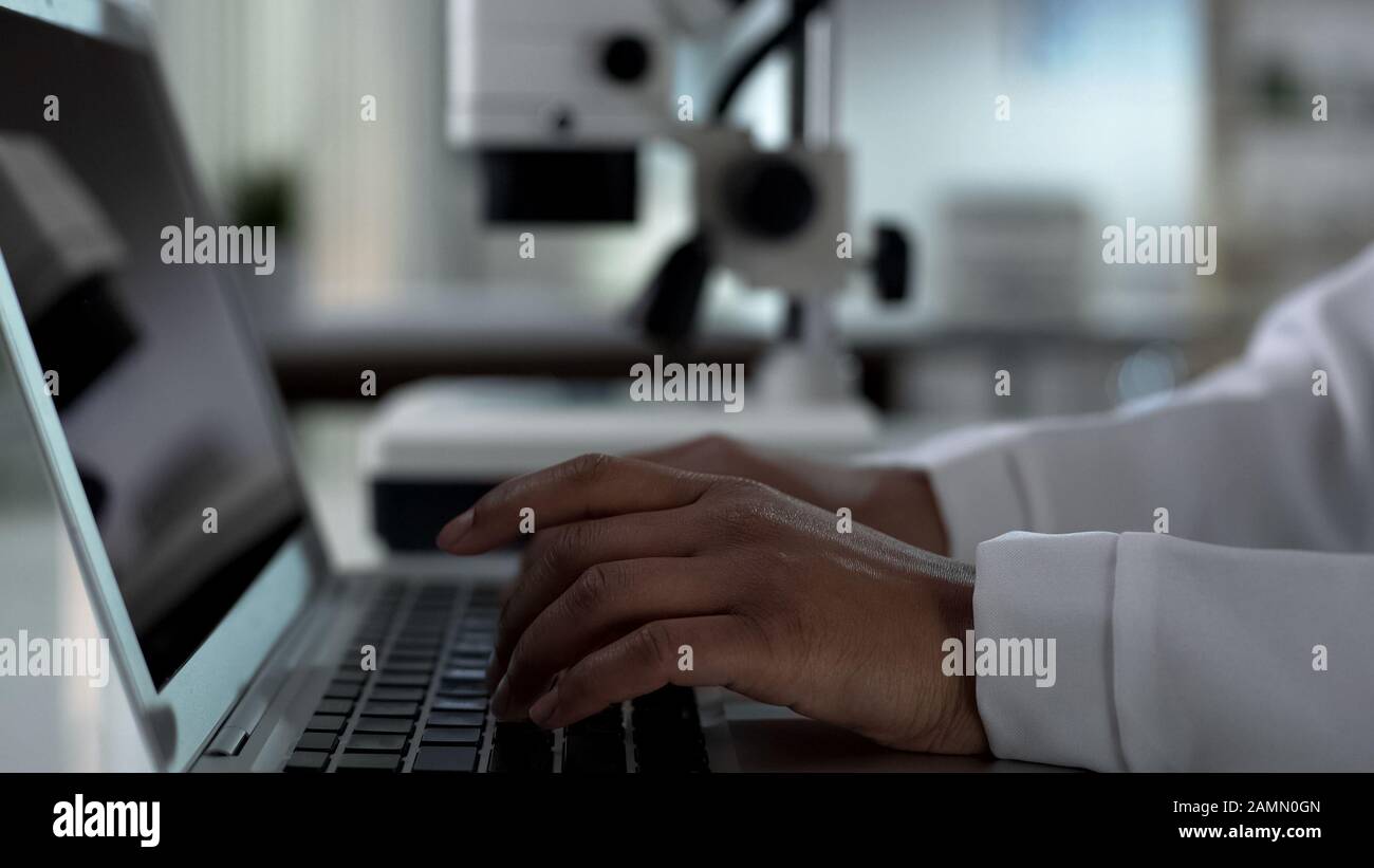 Female scientist hands typing on laptop, working on experimental ...