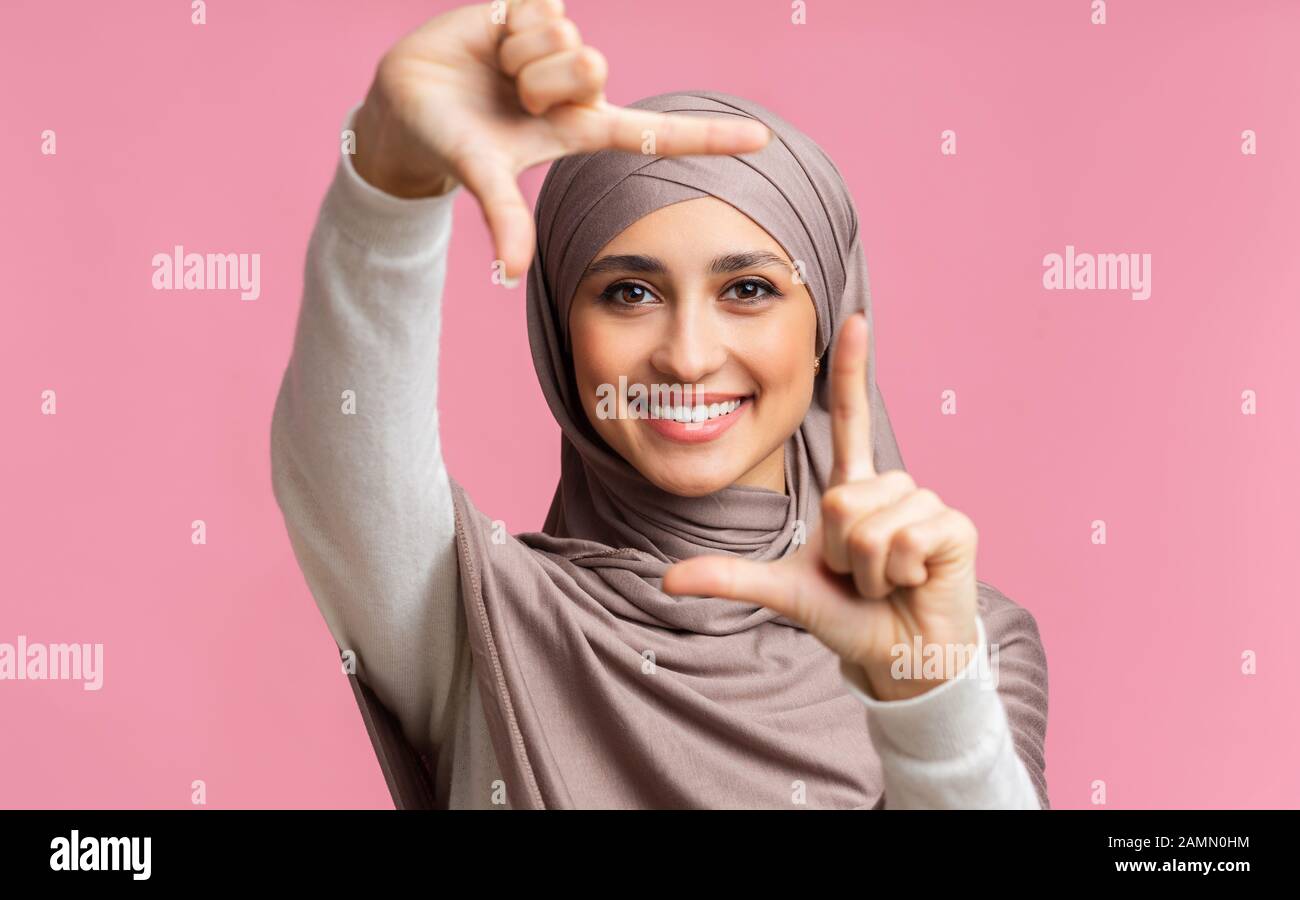 Smiling arabic woman in headscarf making frame with fingers Stock Photo ...