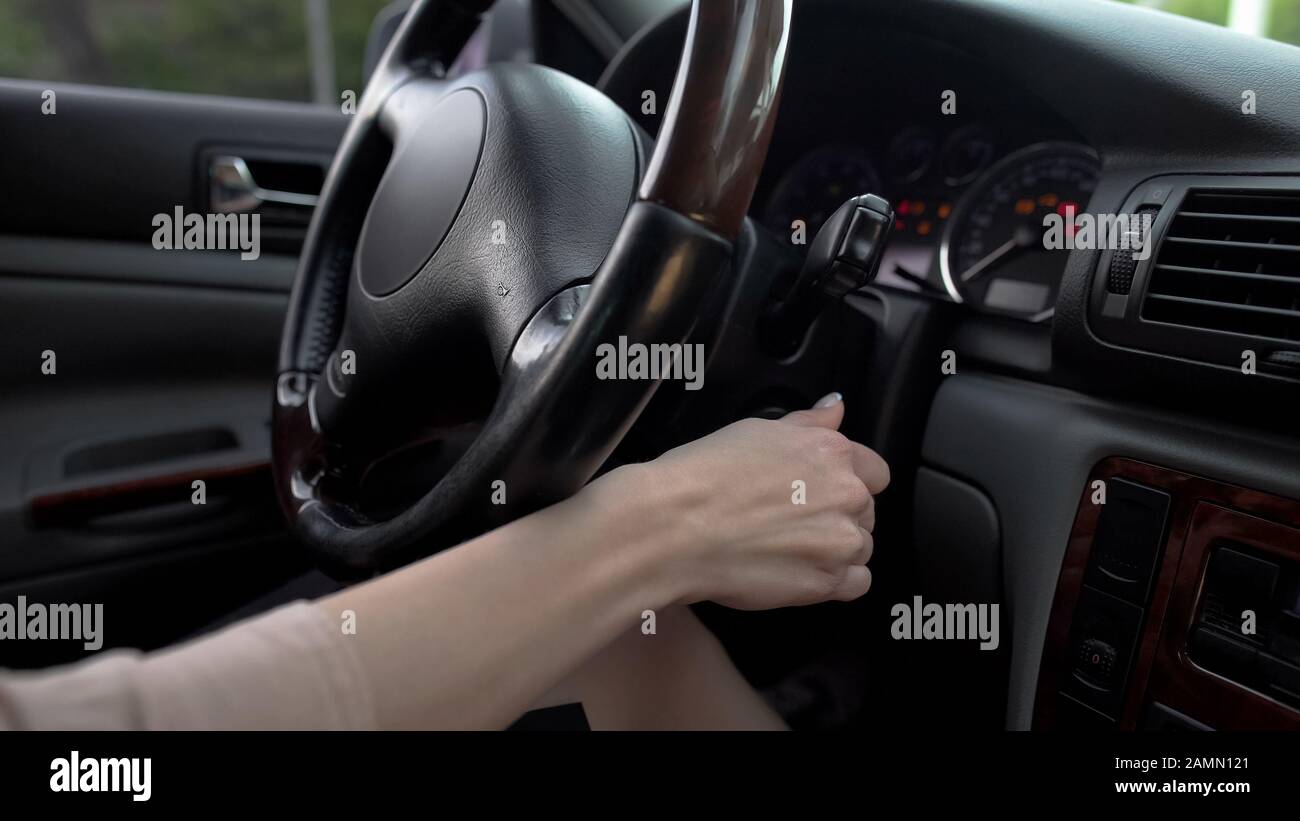 Female hand starting car engine, business woman driving luxury vehicle ...