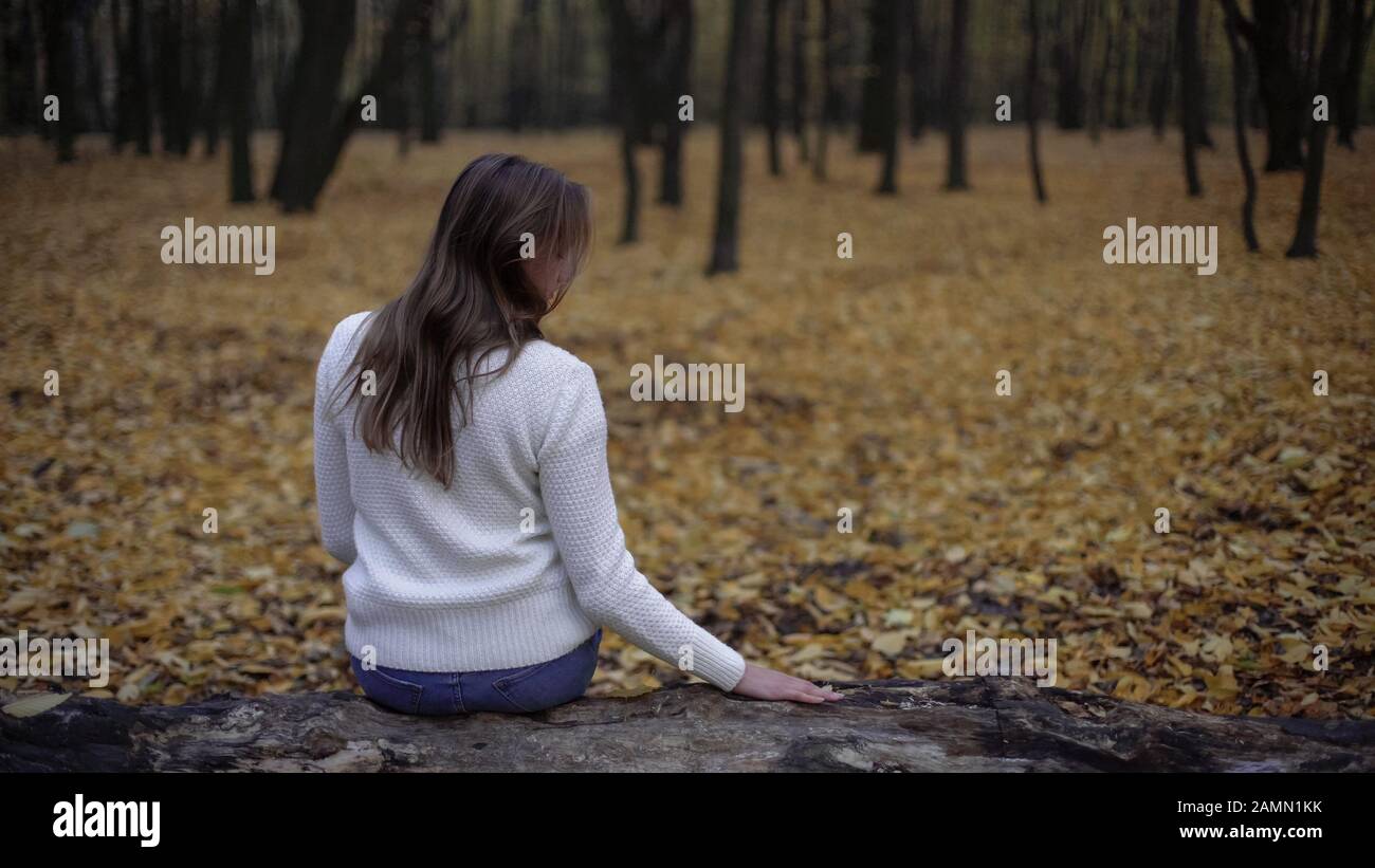 Sad woman sitting in autumn park remembering deceased husband, loss of ...