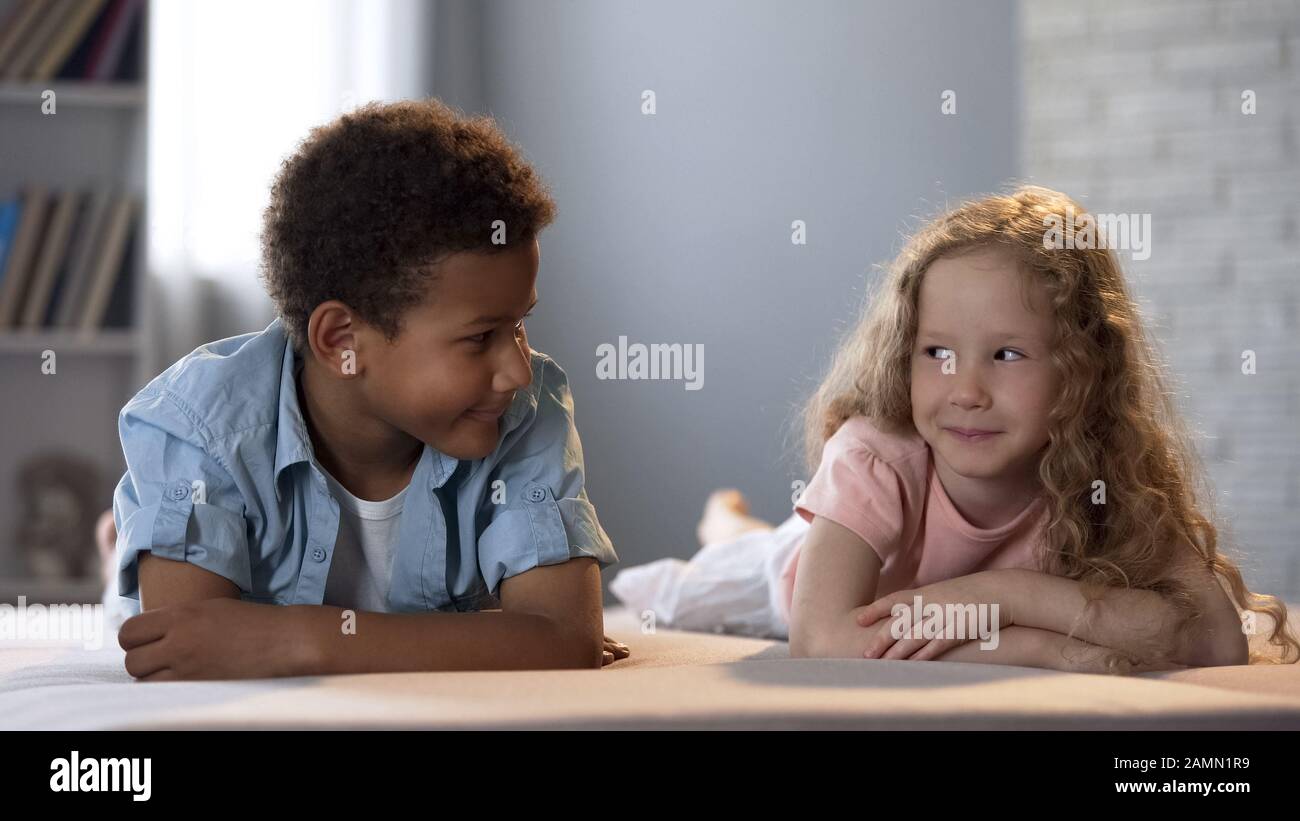 Cute little children clumsily flirting with each other, first childhood ...