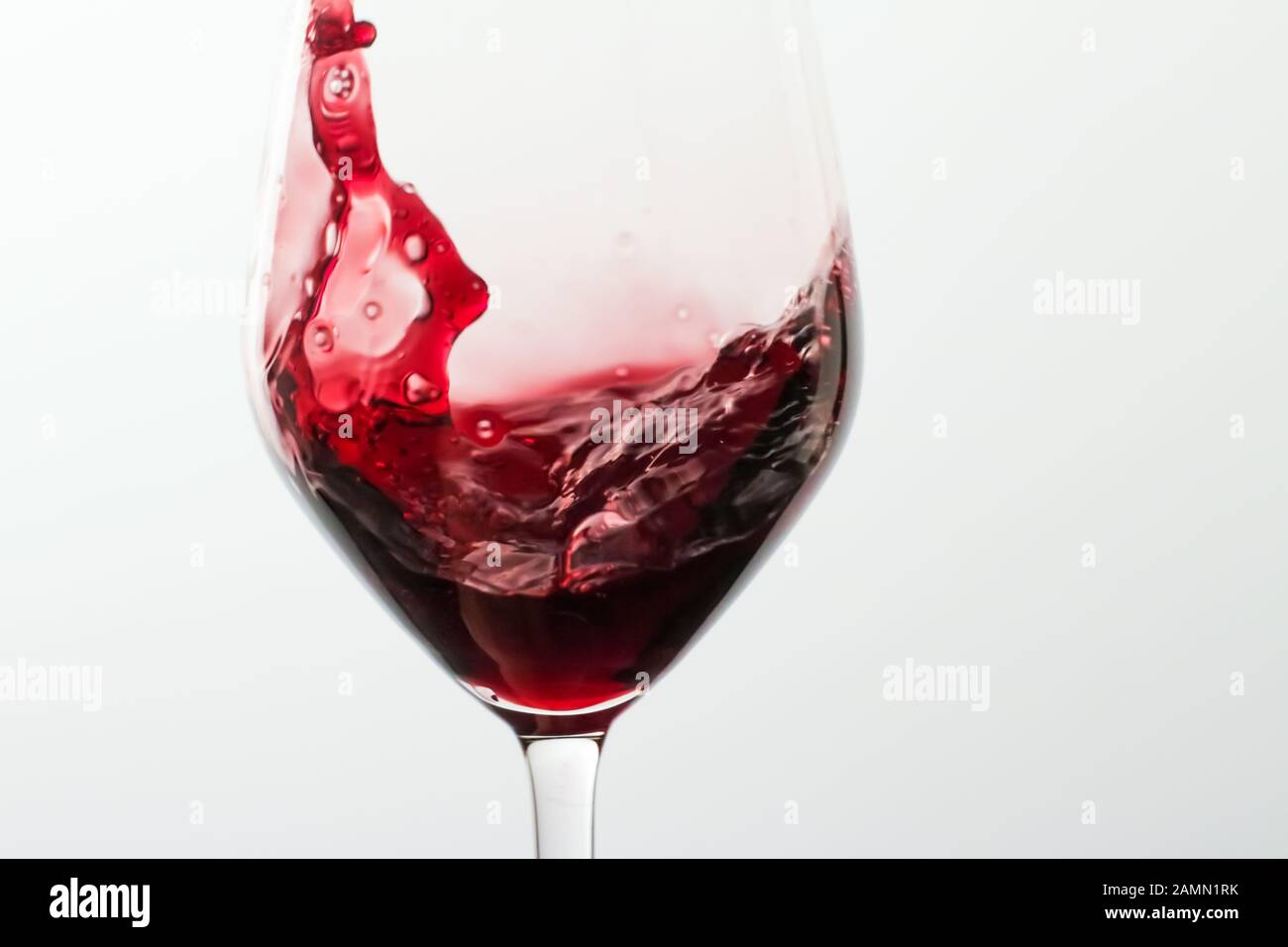 Winery, cheers and winemaking concept - Glass of red wine, pouring ...