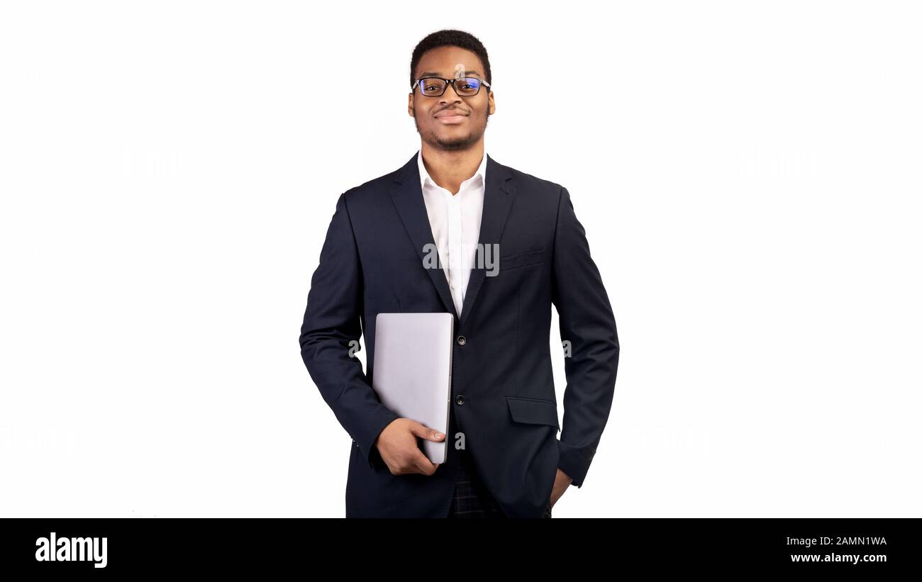 Serious black man holding laptop on white background Stock Photo - Alamy