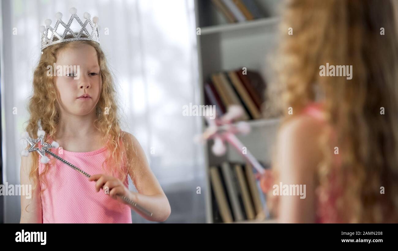 Cute girl princess crown playing with magic stick, love to fairytales ...