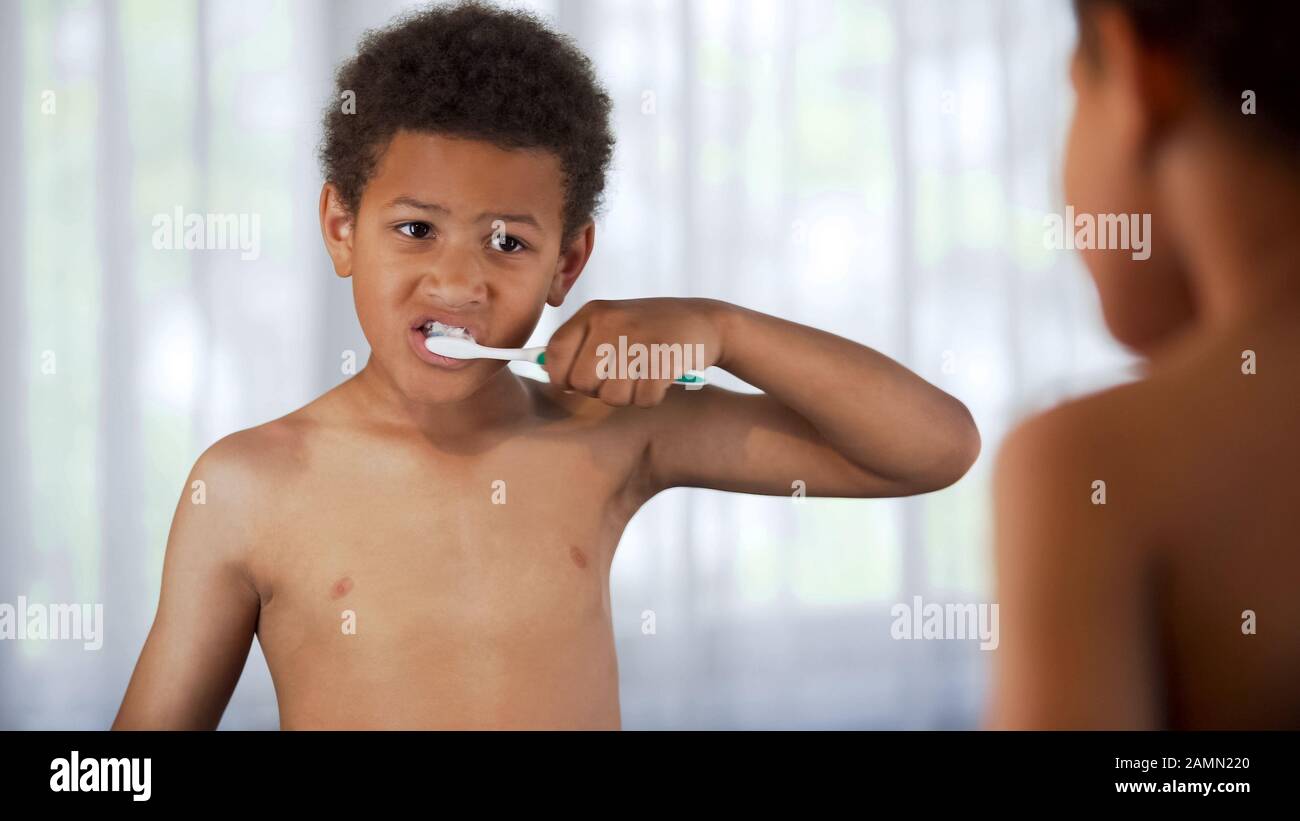 Teen boy brushing teeth hi-res stock photography and images - Alamy