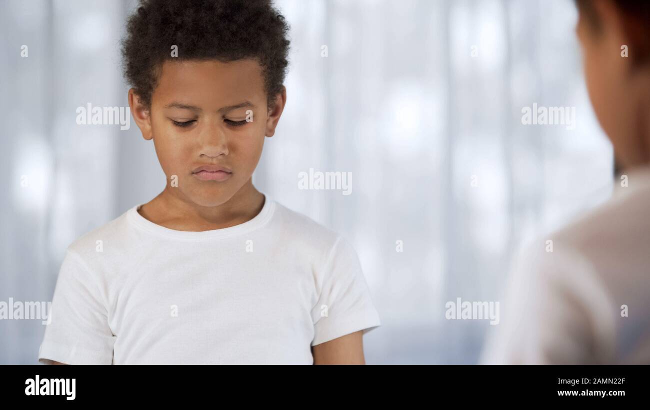 Unhappy boy in mirror reflection, parents fight, school bullying ...