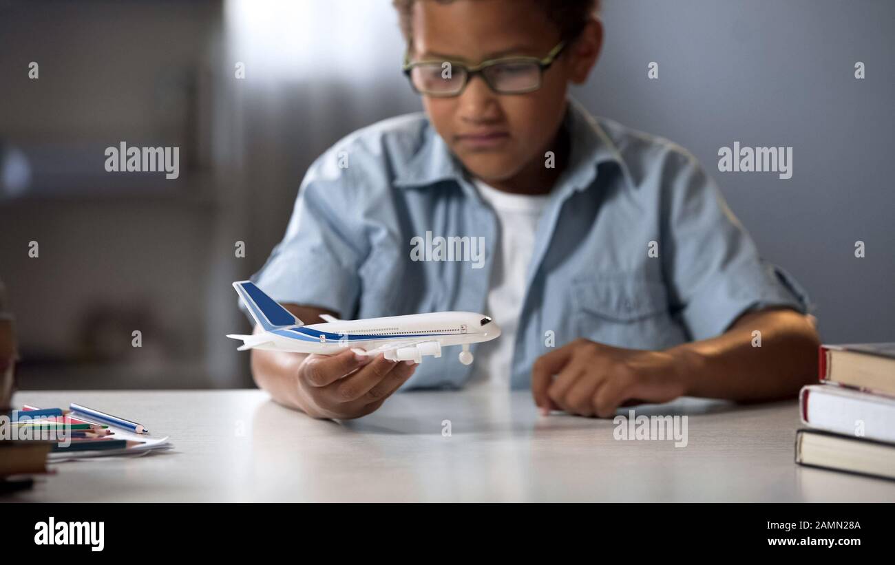 Boy dreaming of becoming pilot of modern airline and flying to faraway ...
