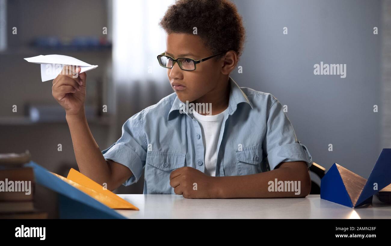 Boy flying paper airplane hi-res stock photography and images - Alamy