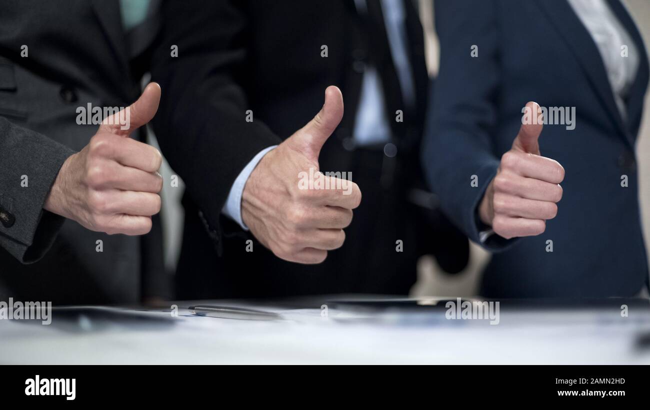 Coworkers showing thumbs up campaign hi-res stock photography and ...