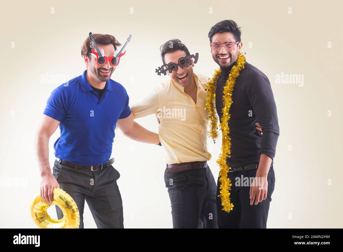 Young men in funky glasses having fun together at a party Stock Photo ...