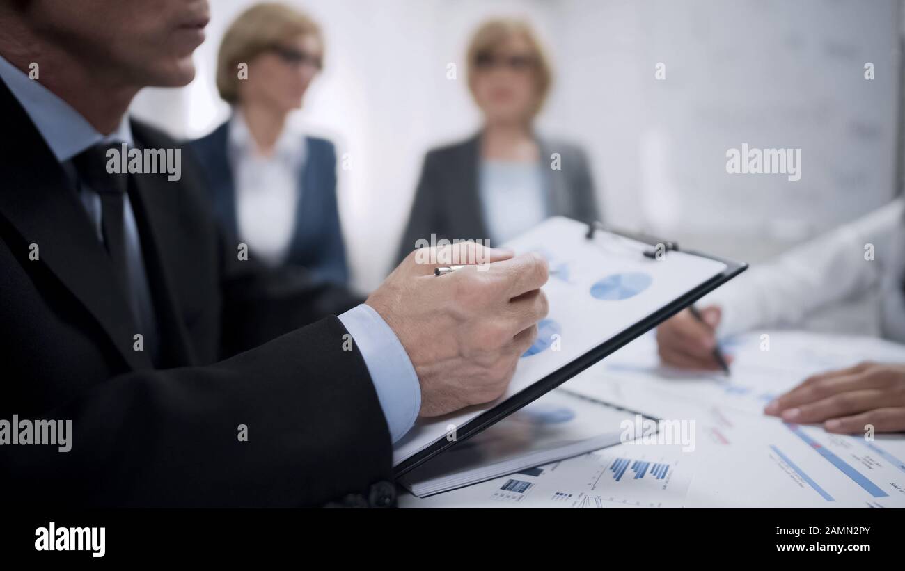 Company management analyzing statistics charts and sharing ideas about ...