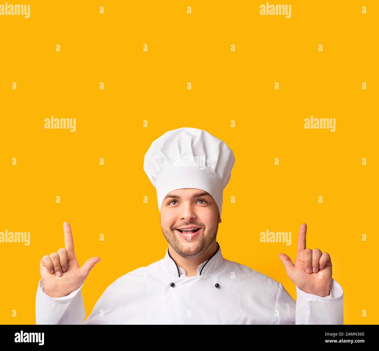 Smiling Chef Man Pointing Fingers Up Over Yellow Studio Background ...
