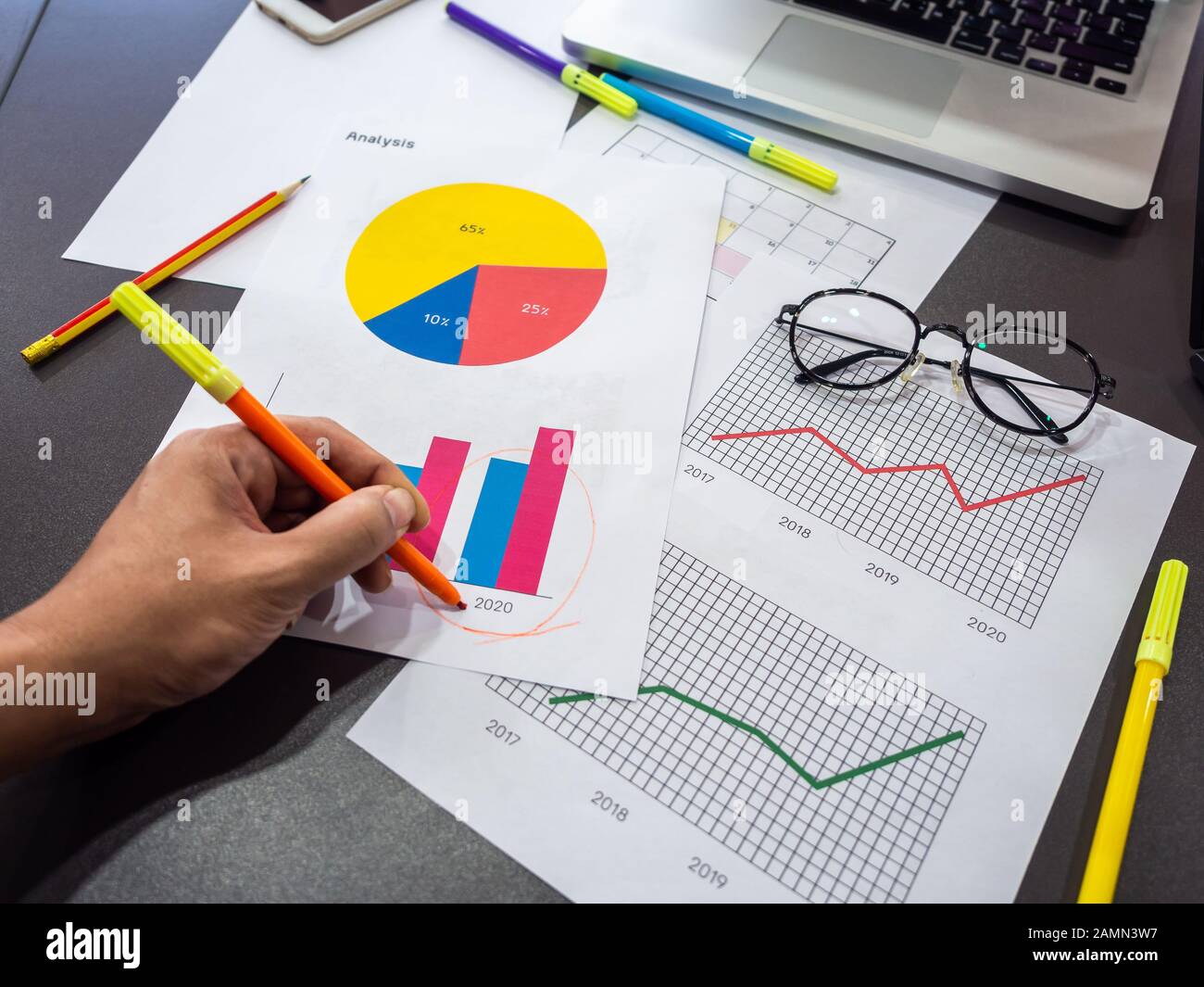 Business goal concept. Hand draw circle around 2020 on diagrams graphs ...