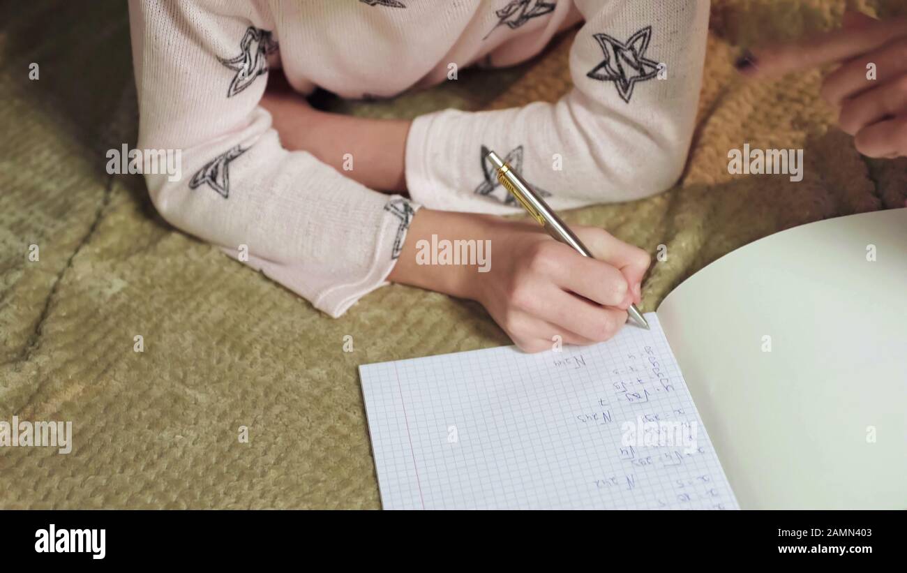 Smart girl solving mathematical equations in bed, homeschooling ...