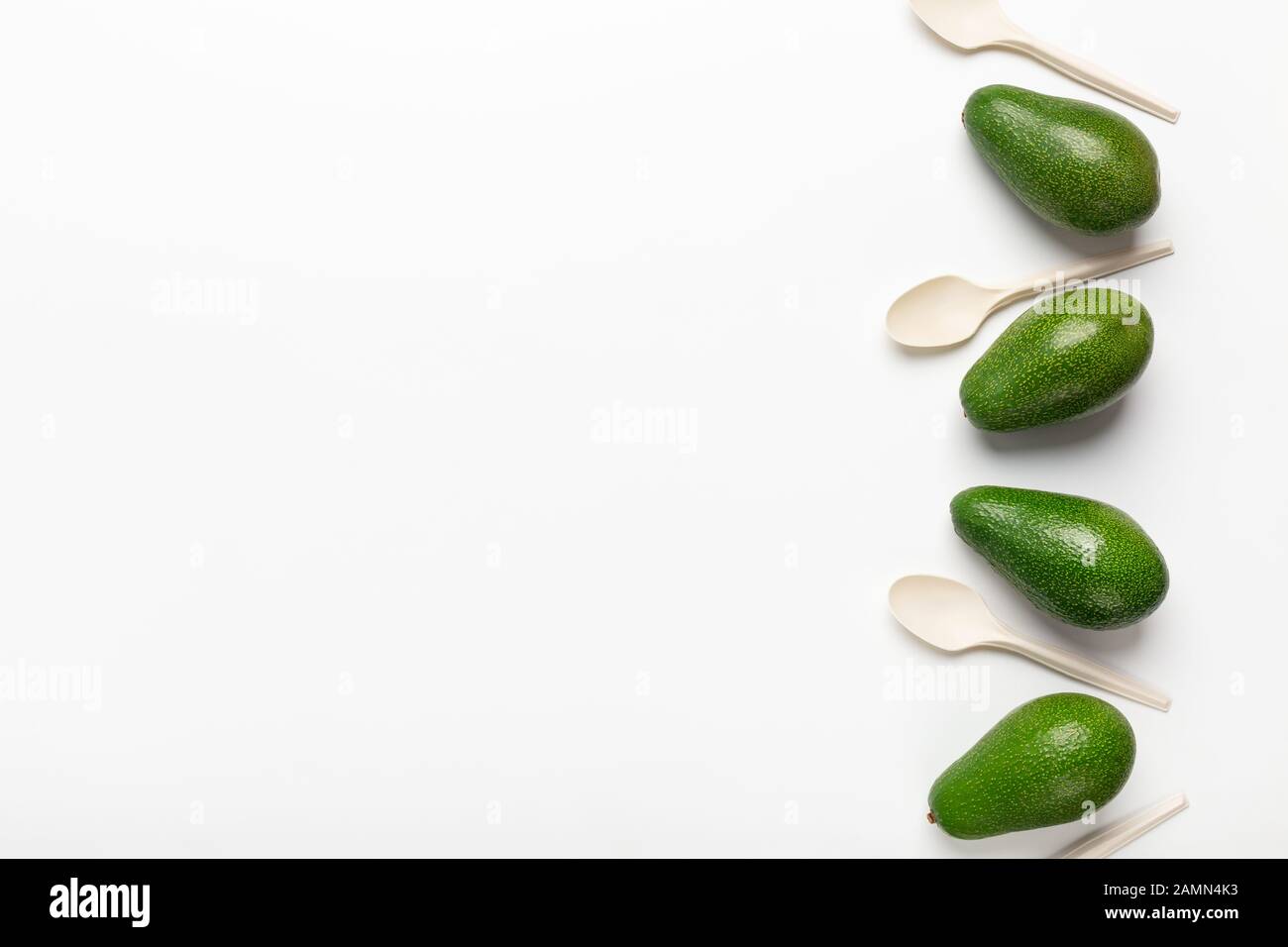 Collage of avocado and disposable spoons on white Stock Photo - Alamy