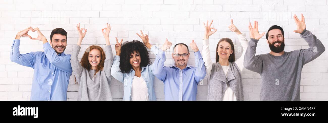 Group of diverse people showing positive signs at studio Stock Photo ...