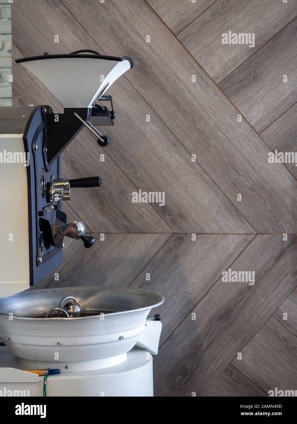 Coffee roaster on wooden wall background with copy space vertical style ...