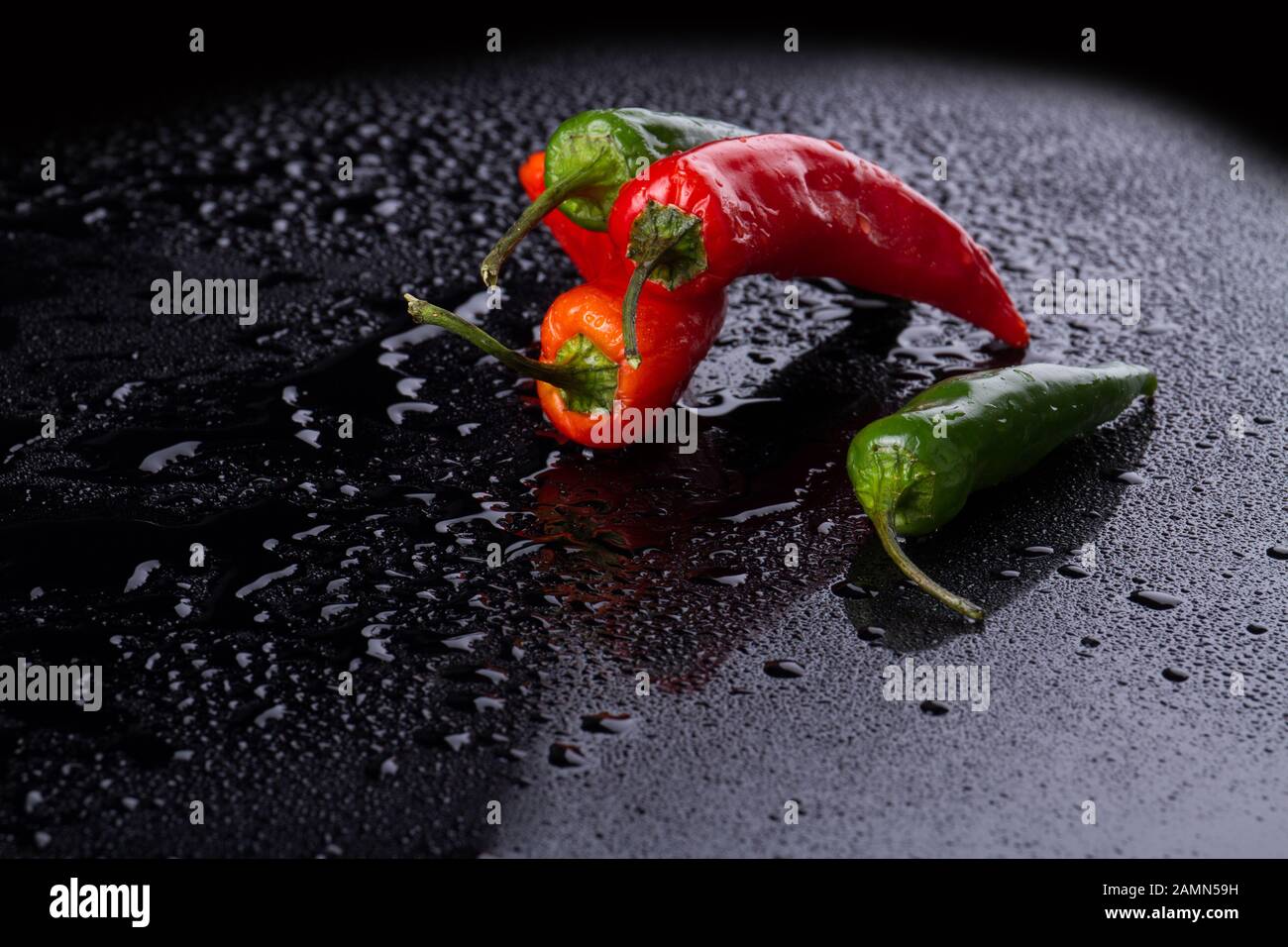 Pepper pods in black studio Stock Photo - Alamy