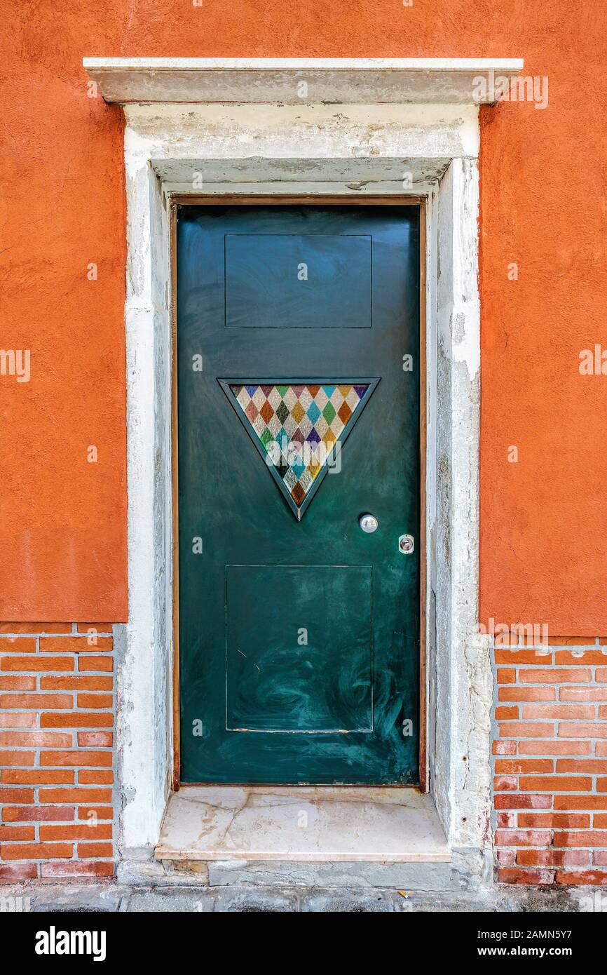 Picturesque green door with glass mosaic triangle on the famous island ...