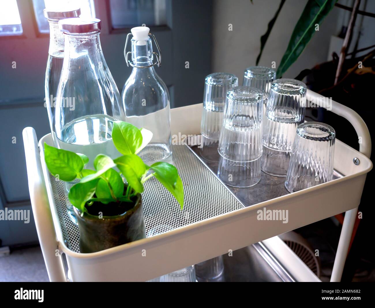 Free drinking water self service set in cafe. Pile of glass in tray and ...