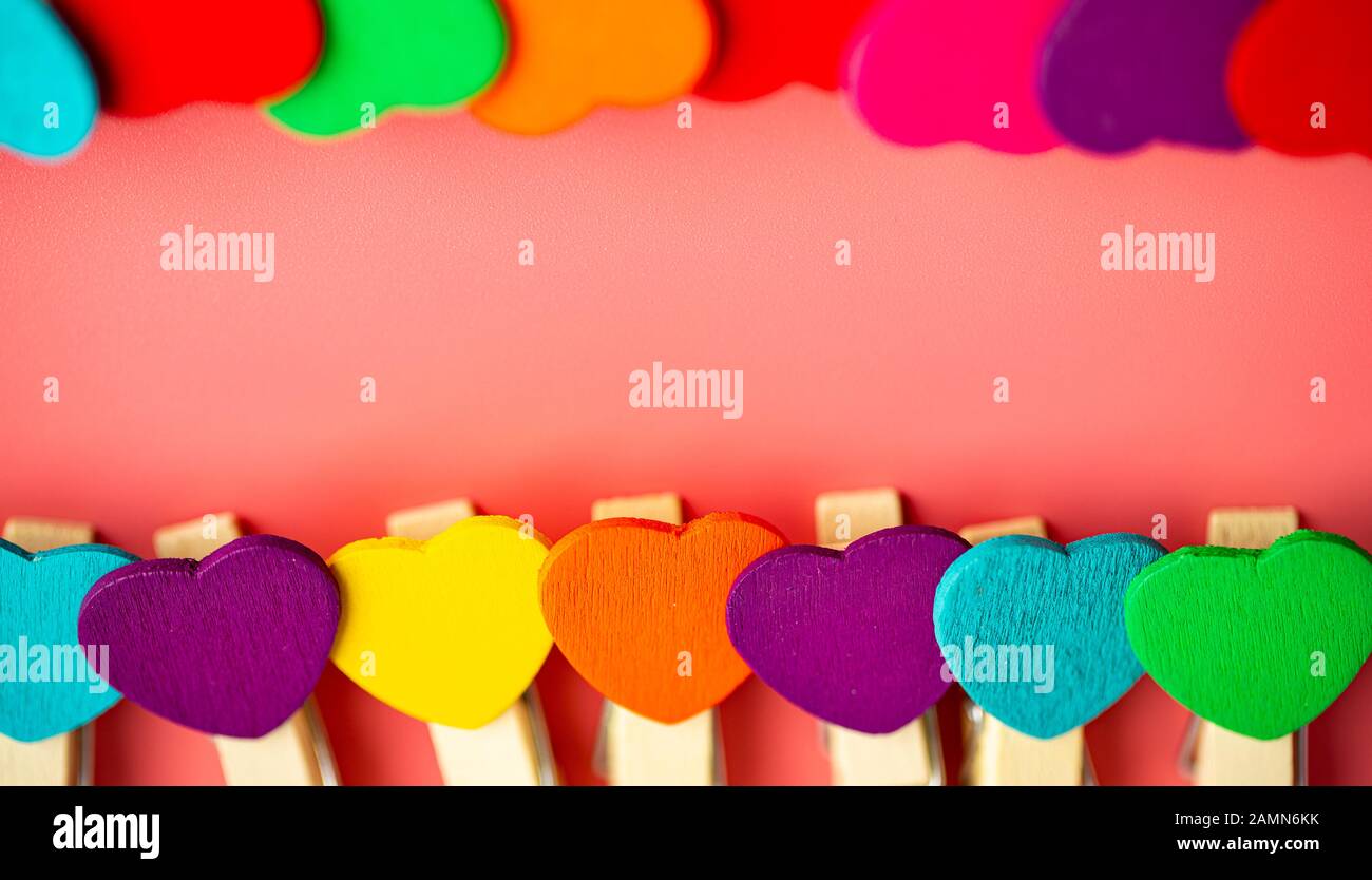 two rows Beauty Colorful mini hearts with pink background and copy ...