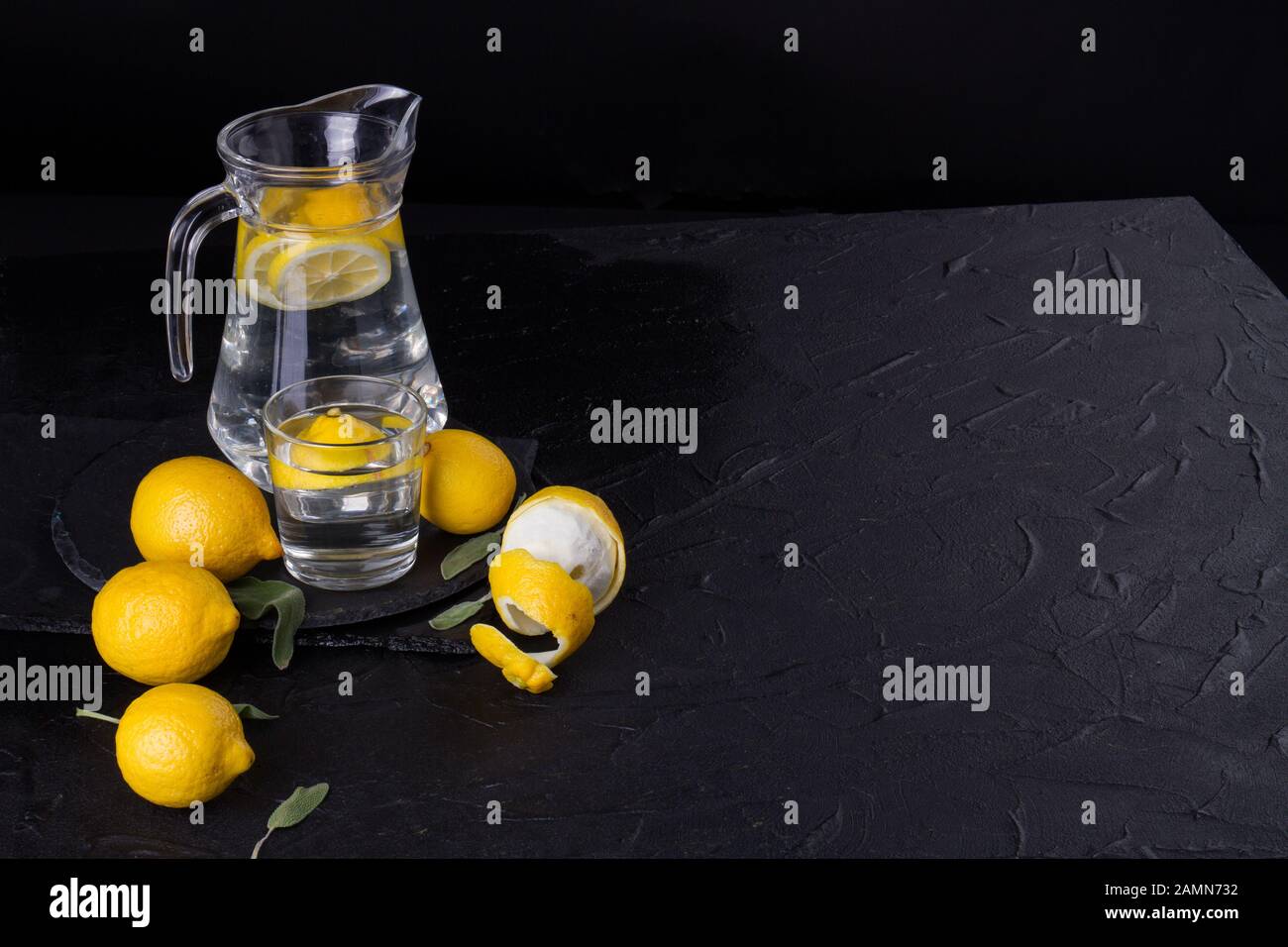 Six lemons and glass of water Stock Photo - Alamy