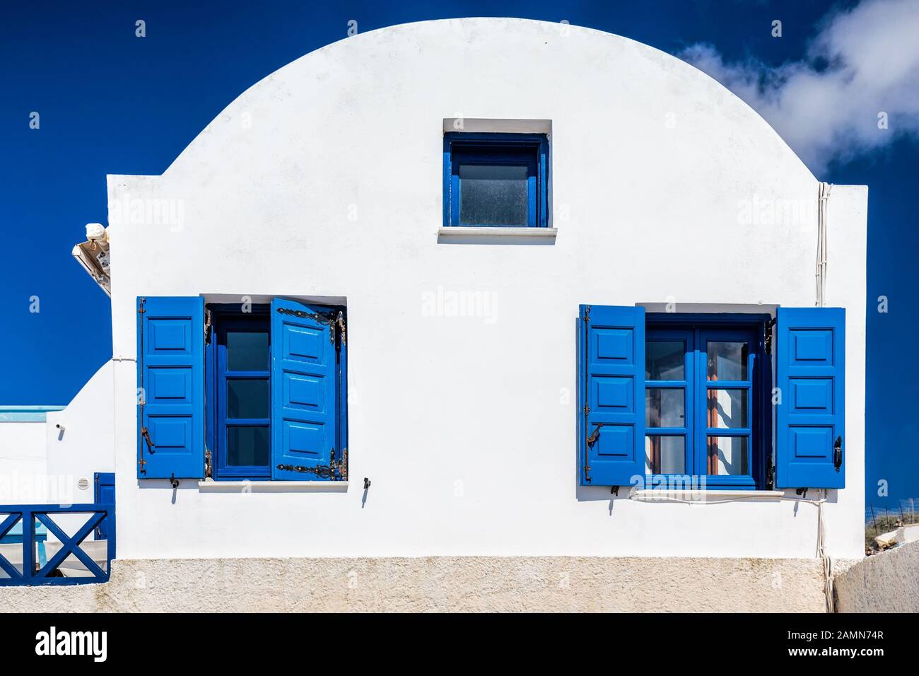 Blue windows with blue shutters and blue fence on white house with oval ...