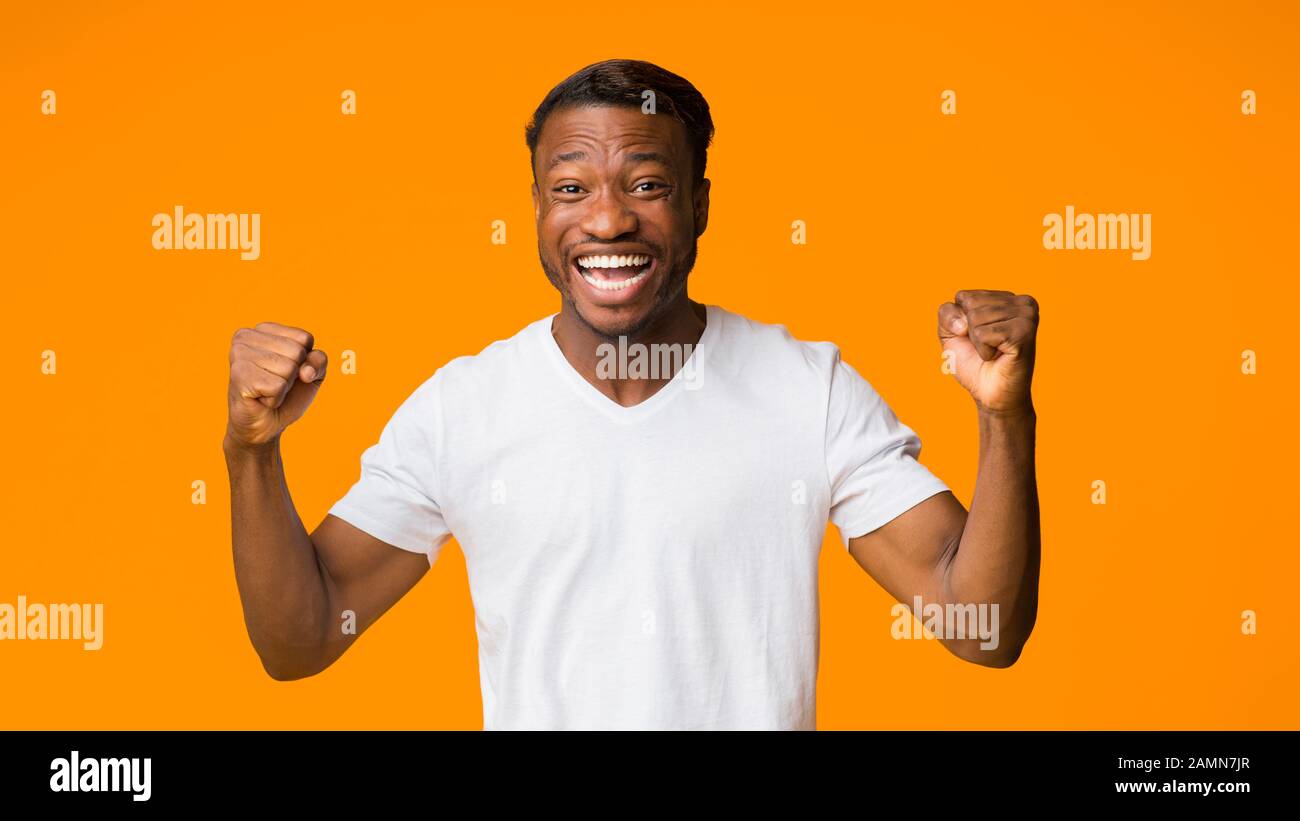 African American Guy Shouting Gesturing Yes On Orange Background ...