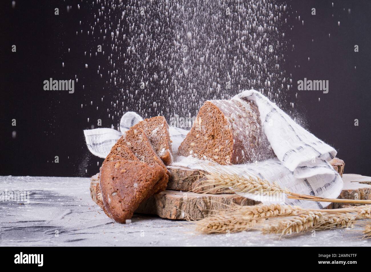 Triangular bread under falling flour Stock Photo - Alamy