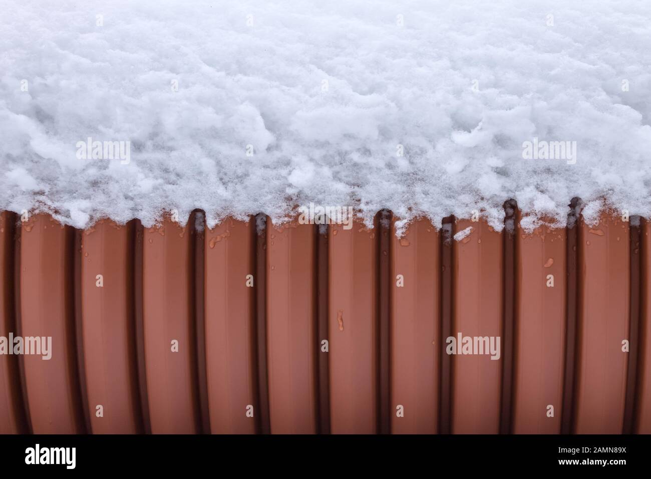 Background, texture of the outer wall of the sewer pipe with snow on ...