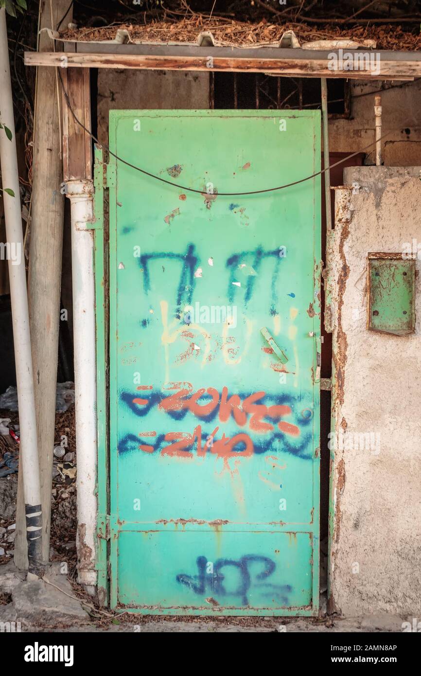 Green iron gate with graffiti in Tel Aviv, Israel Stock Photo - Alamy