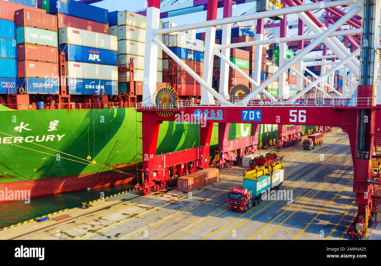 Containers unloaded from a ship are loaded onto a truck on a quay in a ...