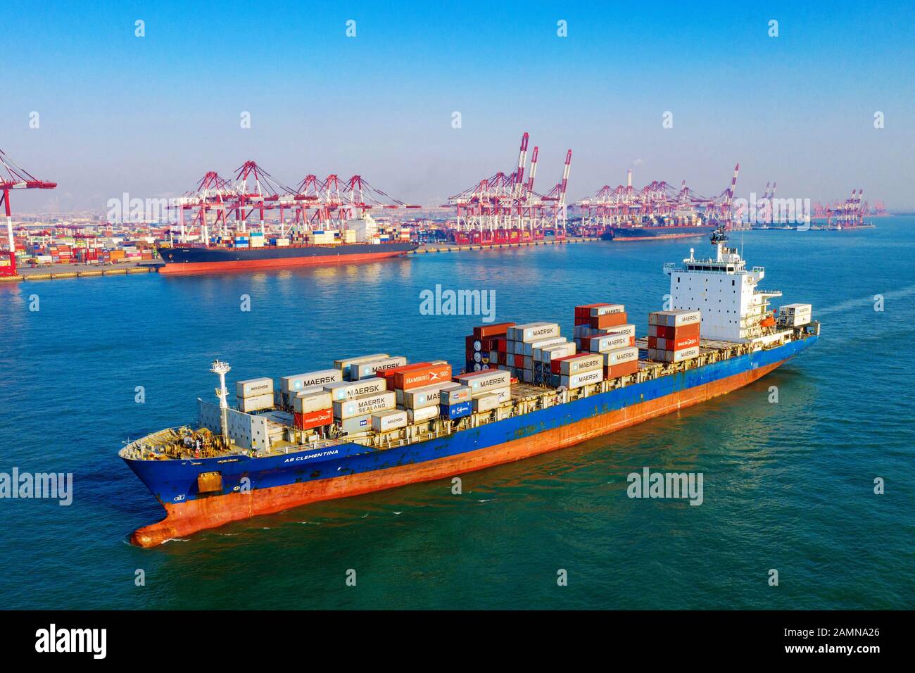 A container ship sails into the Port of Qingdao in Qingdao City, east ...