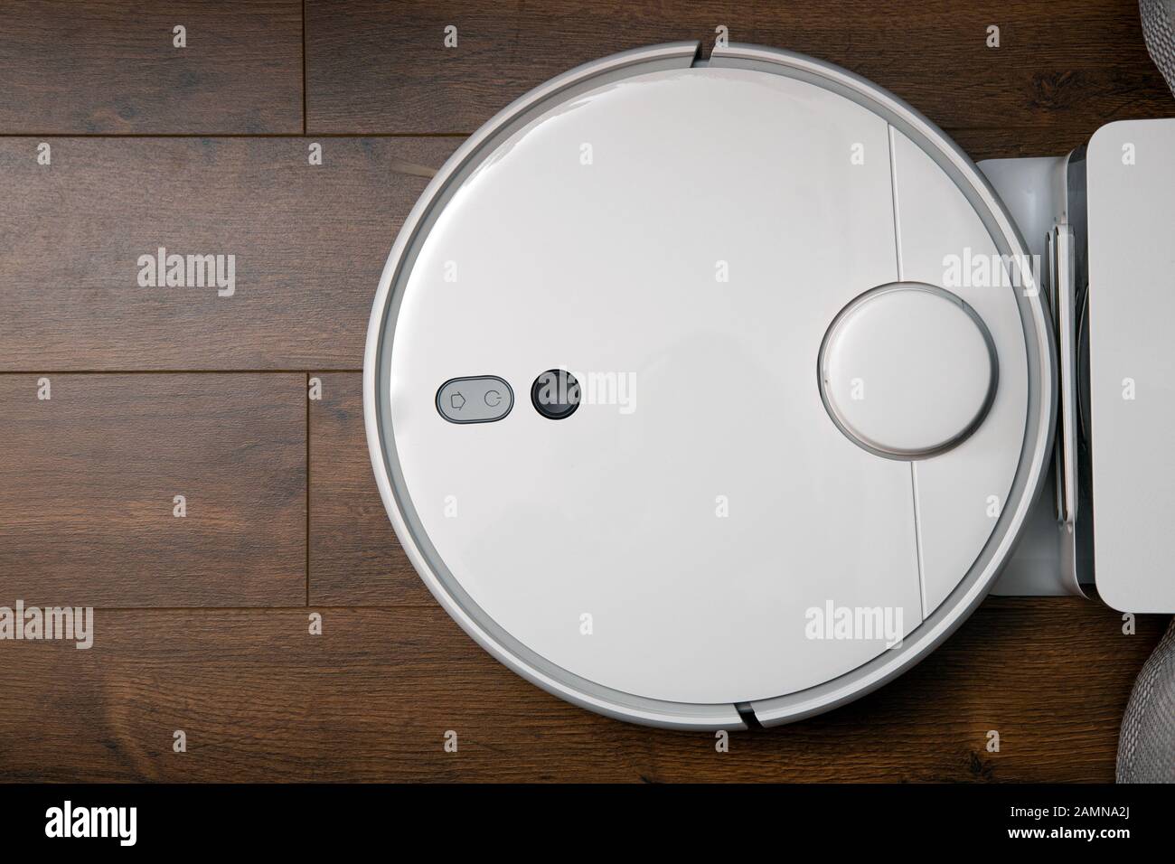 Robotic vacuum cleaner is charging at the preset point.Smart home Stock ...