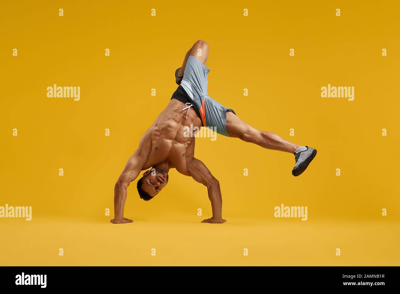 Front view full length of athletic bodybuilder with perfect abs doing ...