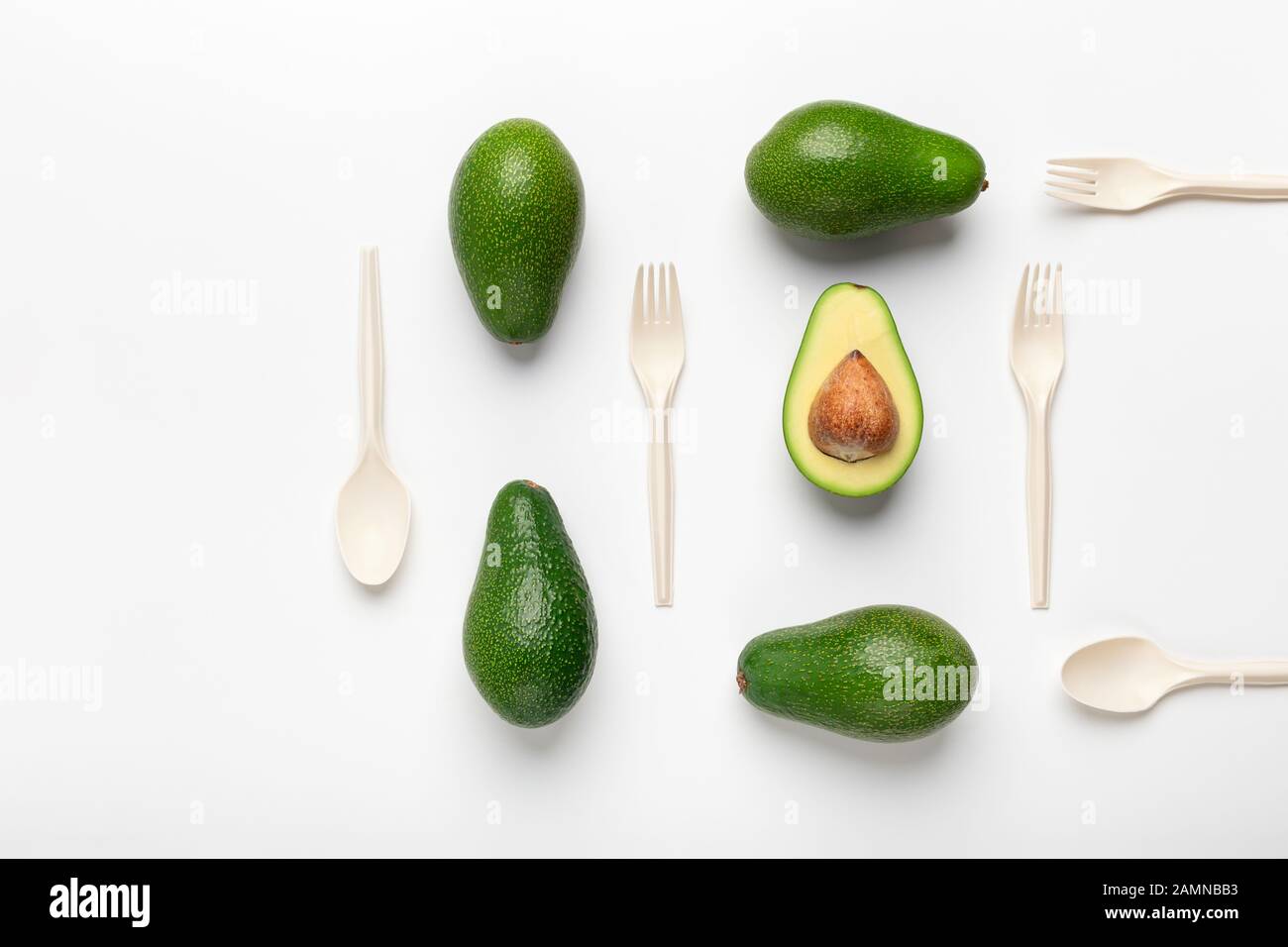 Creative flat lay of avocados and biodegradable Single-Use Cutlery ...