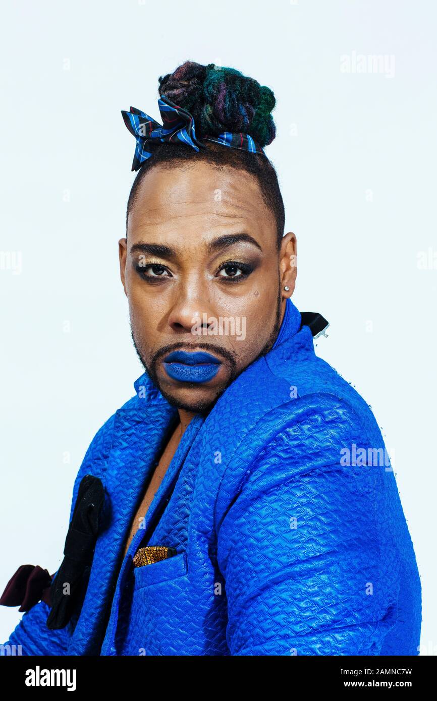 Closeup portrait of a man with blue lips dressing in blue sitting ...