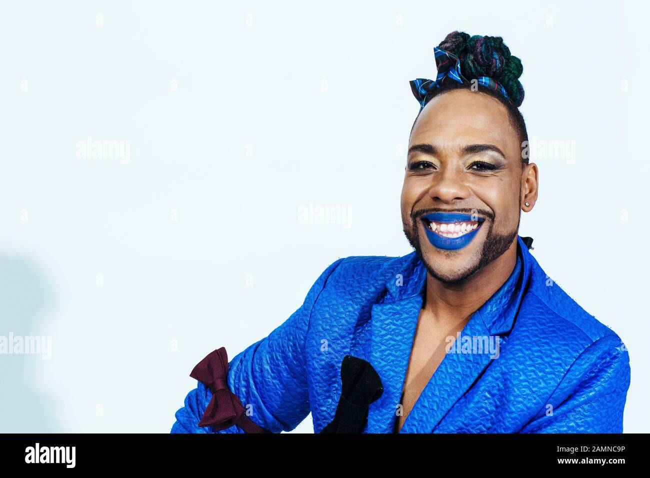 Closeup portrait of a man with blue lips dressing in blue sitting ...