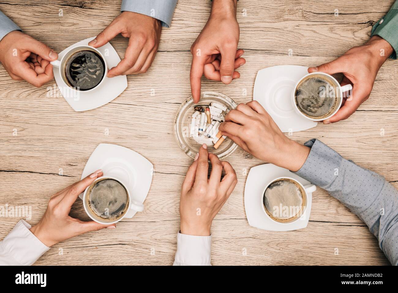 Men smoking cigarettes together hi-res stock photography and images - Alamy