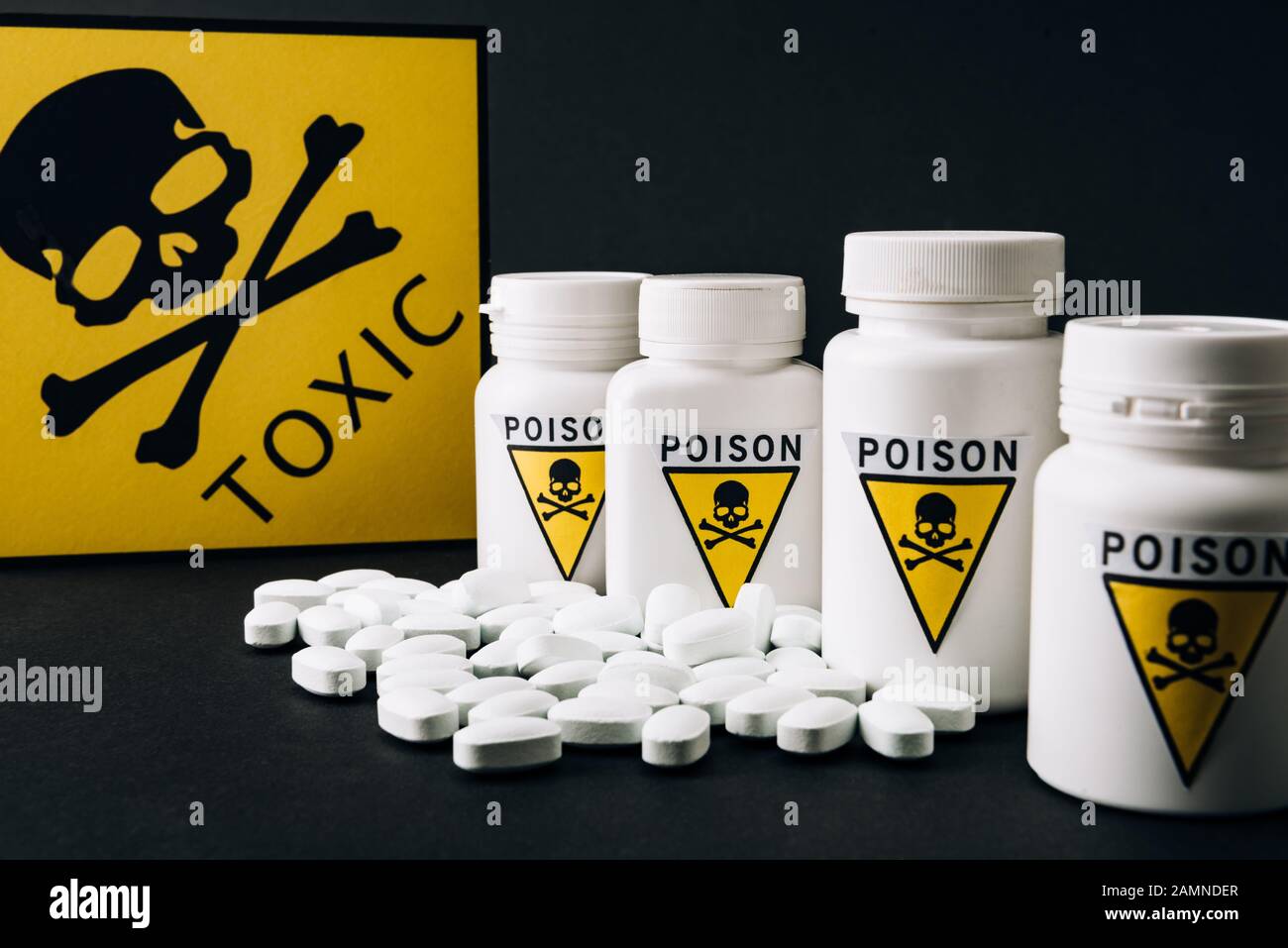 Jars with poison symbol by toxic sign and pills isolated on black Stock ...