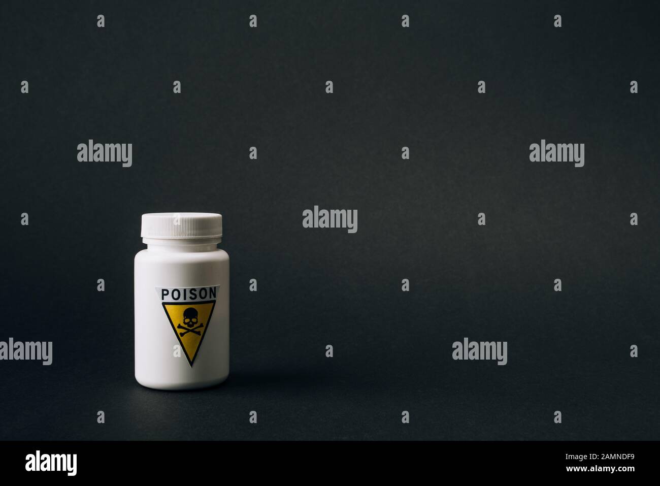 Jar with poison symbol isolated on black Stock Photo - Alamy