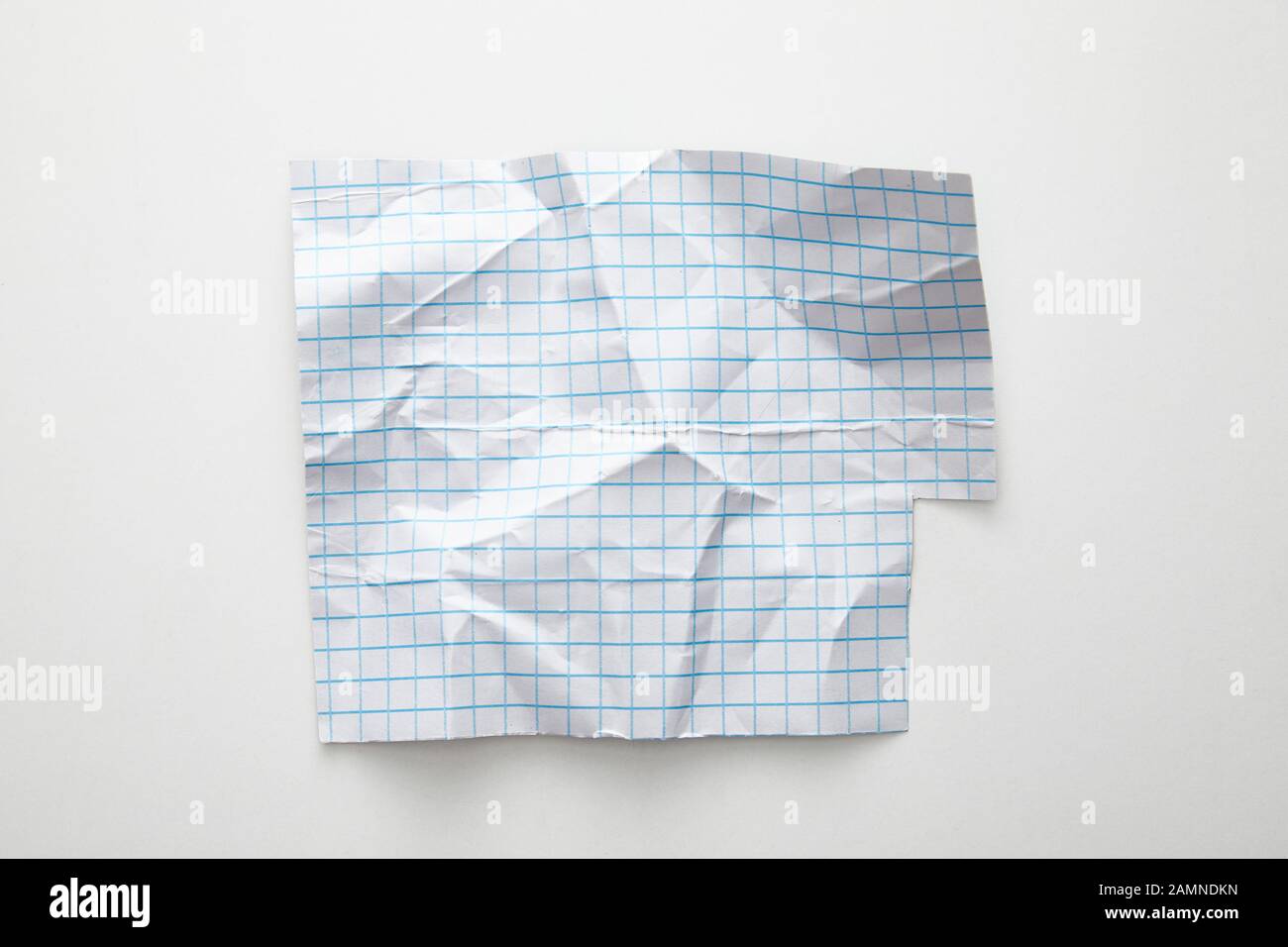 top view of empty crumpled grid paper on white background Stock Photo ...