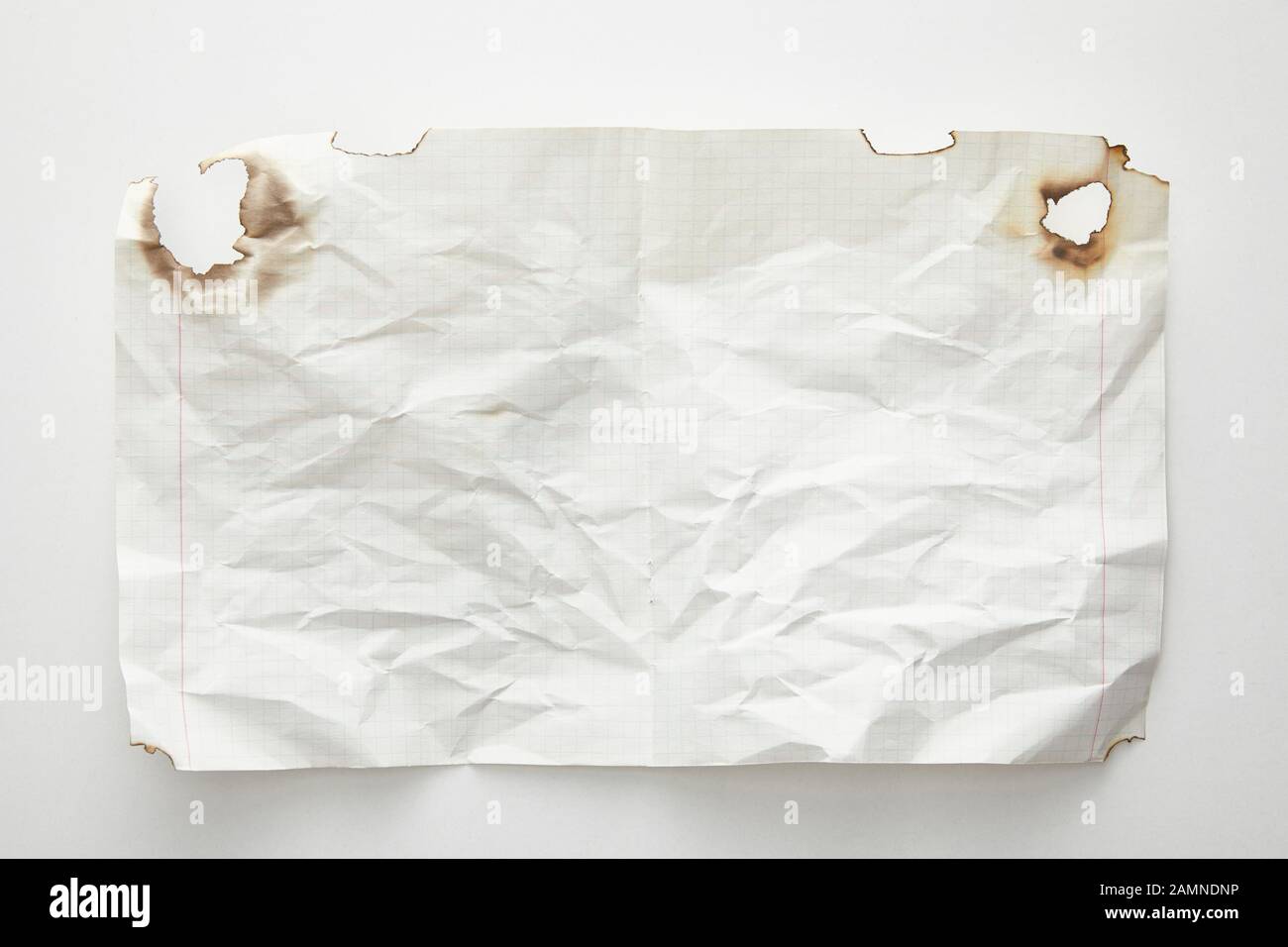 top view of empty crumpled and burnt vintage paper on white background ...