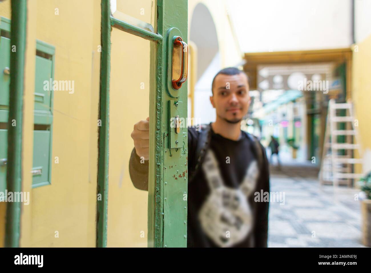 Young man opening front door of house hi-res stock photography and ...