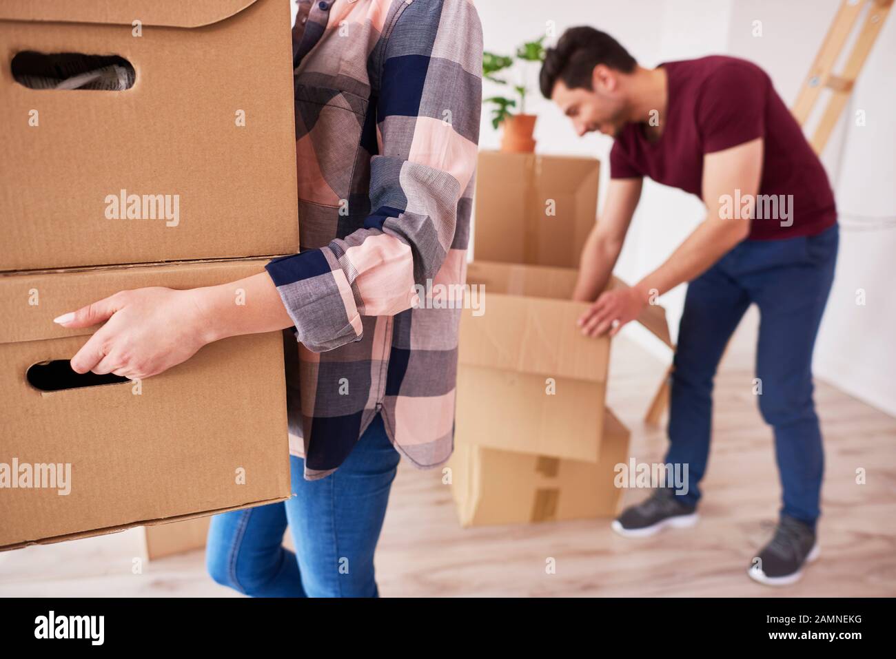 Part of woman carrying cardboard boxes into new apartment Stock Photo ...