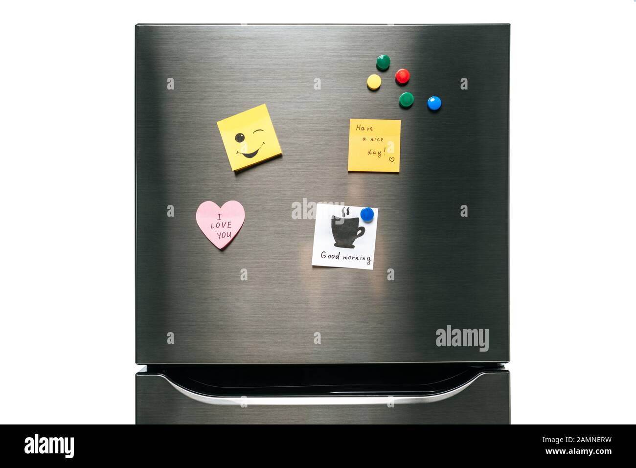notes with wishes and magnets hanging on fridge isolated on white Stock ...